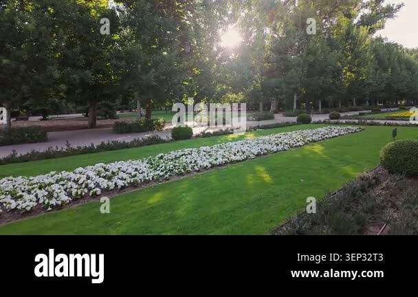 Gardens of the Retiro Park, with colorful flowers and lots of ...
