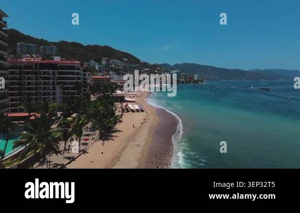 Cinematic 4K aerial dolly-in movement glides from open turquoise sea ...