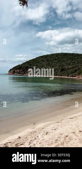 Peaceful shoreline with transparent water, soft sand, distant islands ...