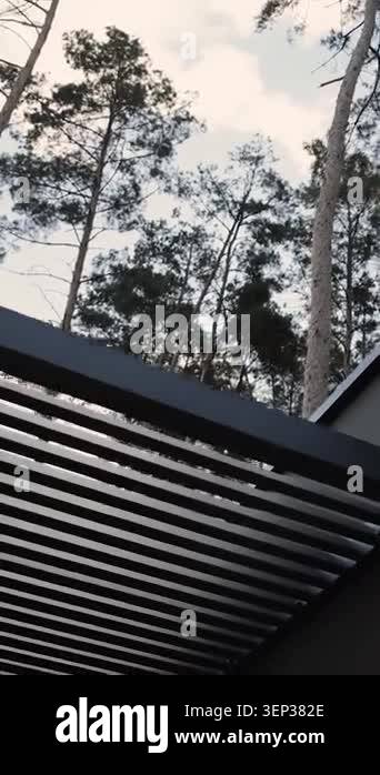 Vertical video. Slatted terrace roof with modern house architecture ...