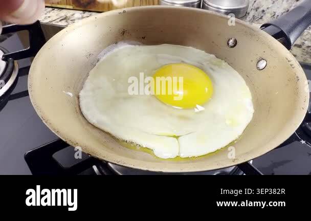 Cooking eggs in the pan, Home made cooking Stock Video Footage - Alamy