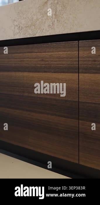 Vertical video. Modern kitchen cabinet with marble countertop and ...