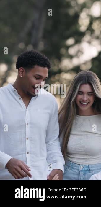 Joyful couple enjoying a romantic walk together in a park. Man and ...