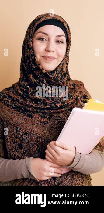 Confident young muslim woman wearing a traditional hijab and holding ...