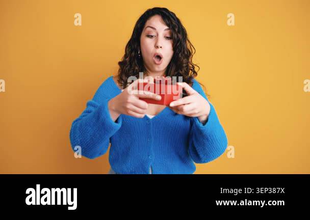 Young woman with curly hair showing great excitement and joy while ...