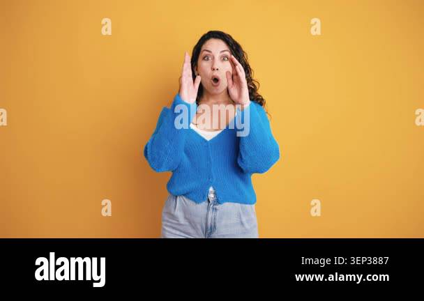 Beautiful young woman with curly hair showing an expression of shock ...