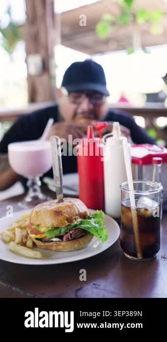 Close up of a complete meal with a cheeseburger, french fries, soda ...