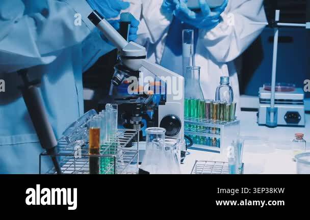 scientist in protective gloves working on laboratory research and ...
