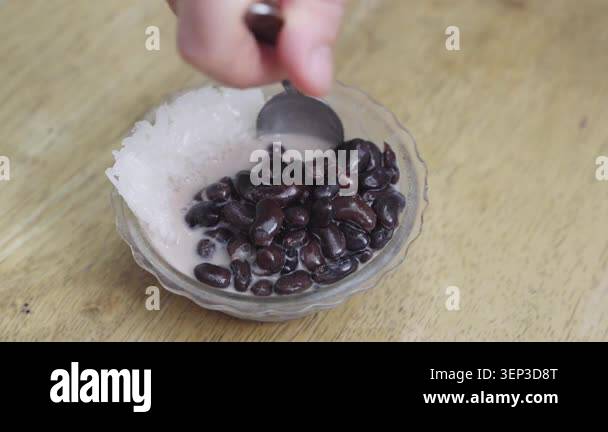 Traditional Thai dessert of sweet sticky rice with black beans in ...