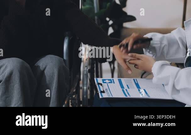 doctor in a white uniform, holding a patient, a man in an wheelchair ...