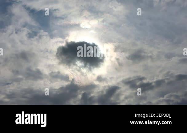 Gloomy clouds passing in front of the sun, creating a dramatic and ...