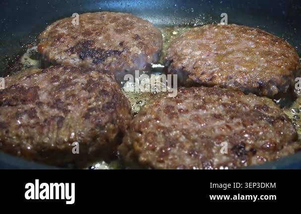 Delicious homemade minced beef patties cooking on a hot skillet for a ...