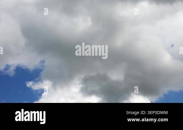 Time lapse Puffy white and grey cumulus clouds moving and transforming ...