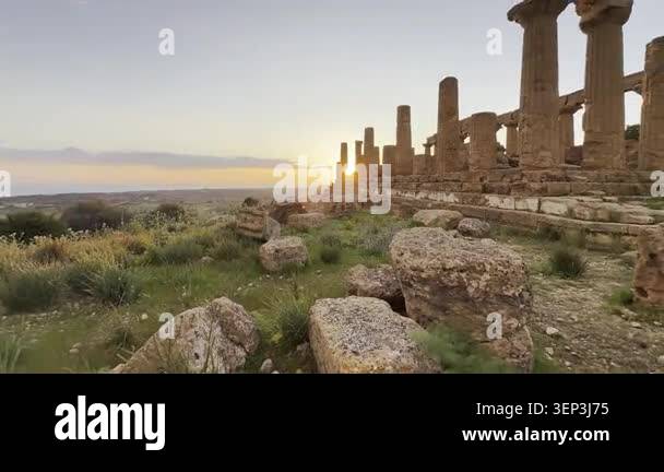 Ancient Greek temple ruins stand on a hill at sunrise in the Valley of ...