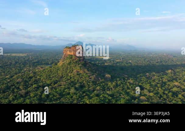 Drone view of Sigiriya Rock Fortress surrounded by dense tropical ...