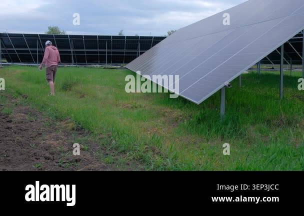 a man is standing on the roof with the solar panels Stock Video Footage ...