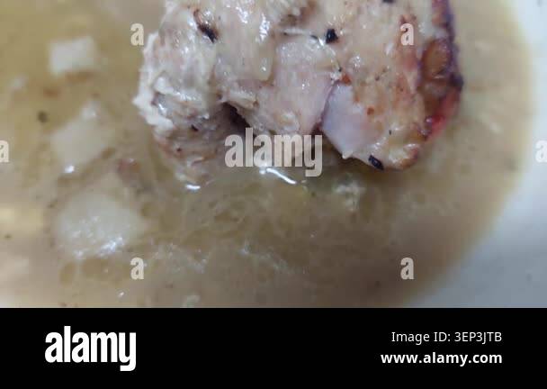 Close-up of cooked meat with thick onion gravy sauce on a plate Stock ...