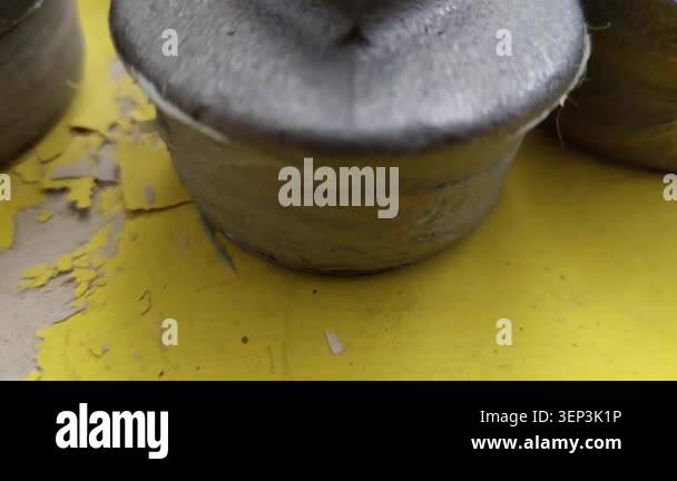 Top down close up view of metal pipe plugs with gray sealing compound ...