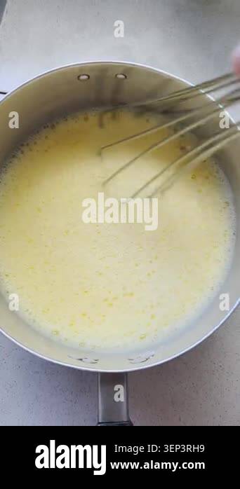 hand whisking in a saucepan on the kitchen counter Stock Video Footage ...