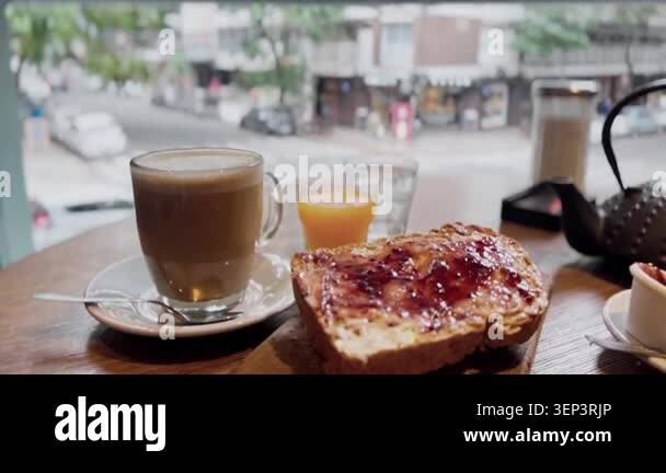 cafe breakfast with latte coffee, orange juice, jam toast and teapot by ...