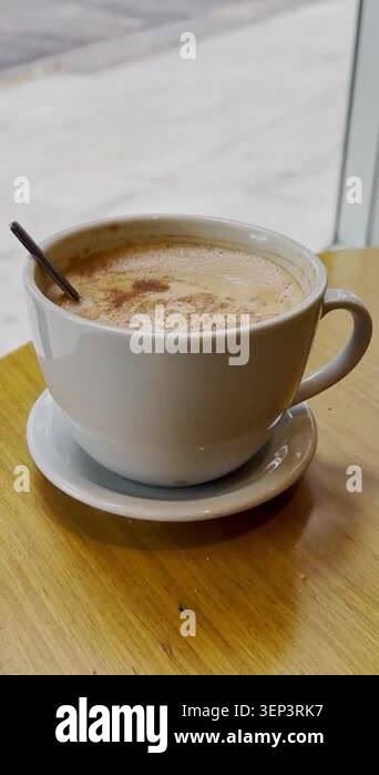 cappuccino in a white cup on a wooden table cafe Stock Video Footage ...