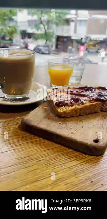 coffee and jam toast breakfast on wooden table by cafe window Stock ...
