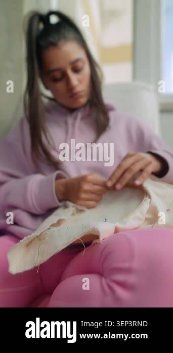 Young white woman sewing on couch, teen seamstress mending vintage ...