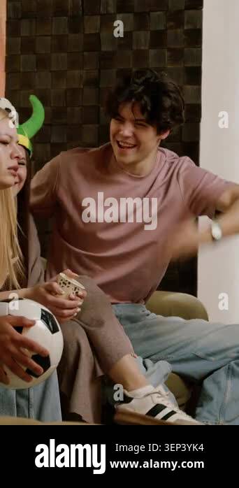 Young Caucasian friends share a lighthearted moment, with one wearing a ...
