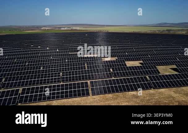 Aerial perspective of solar panel field showcasing rows of photovoltaic ...