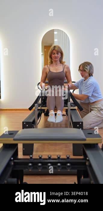A woman in activewear does pilates exercises for the chest and back ...