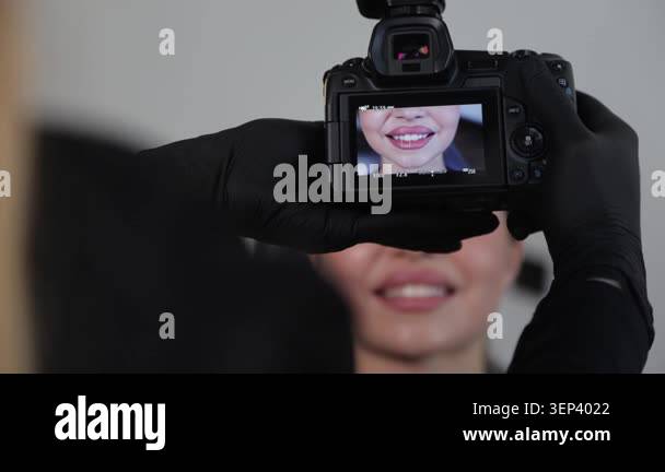 Professional dentist taking a picture of a womans beautiful smile with ...