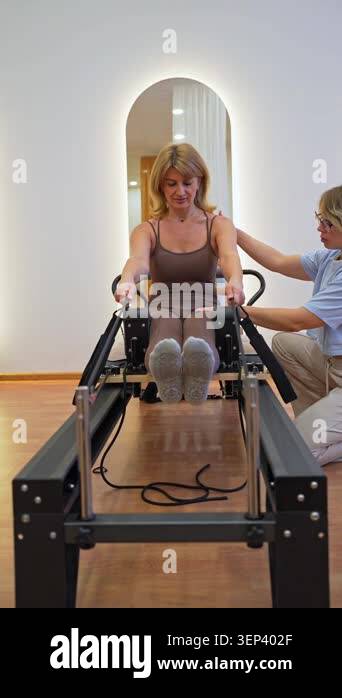 A woman in activewear does pilates exercises for the chest and back ...