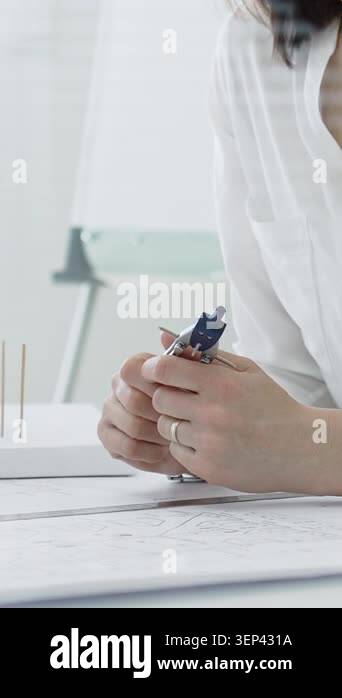 Architect hands measuring and drawing on a blueprint, developing modern ...