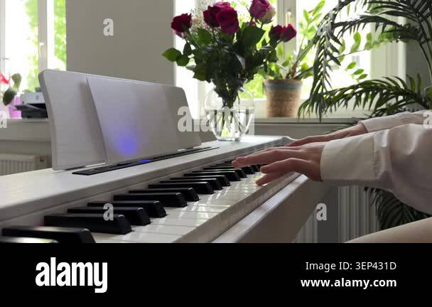 Female Pianist Performing Music on Digital Piano in Sunlit Living Room ...