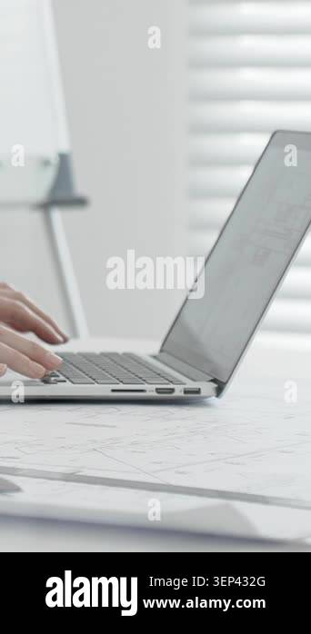 Woman architect working on a laptop, designing and planning ...