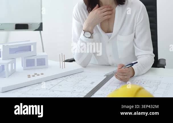 Architect hands measuring and drawing on a blueprint, developing modern ...