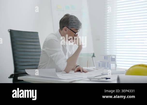 Professional architect concentrating on building a miniature paper ...