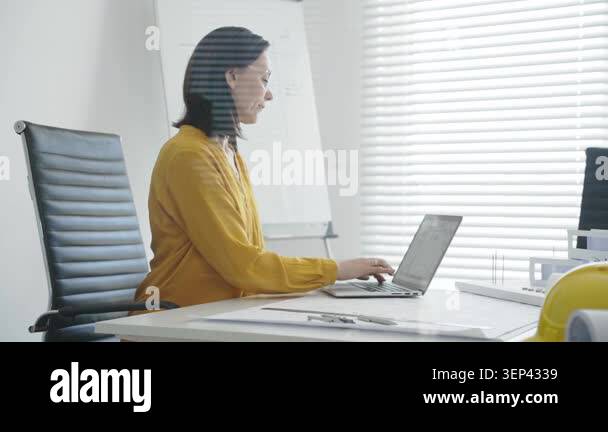 Woman architect working on a laptop, designing and planning ...