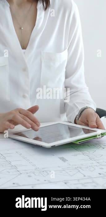 Woman professional working on building plans and design project using ...