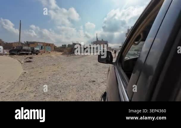 31.12.2025, Socotra, Yemen. Street view from a car window with vehicles ...
