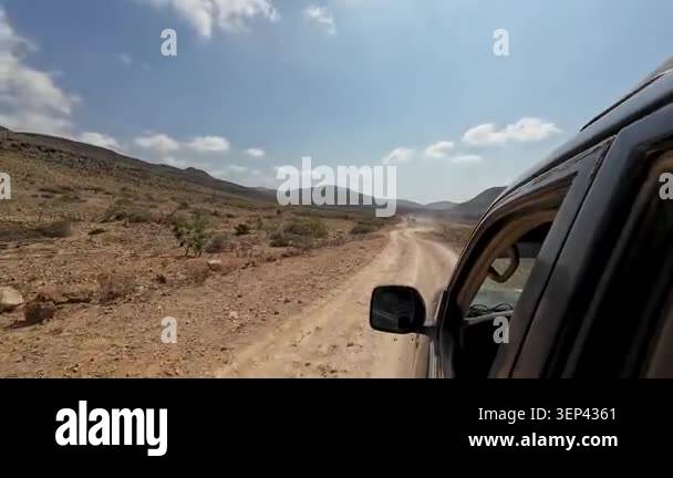 Two suvs driving on a dusty desert road with luggage on the roof Stock ...