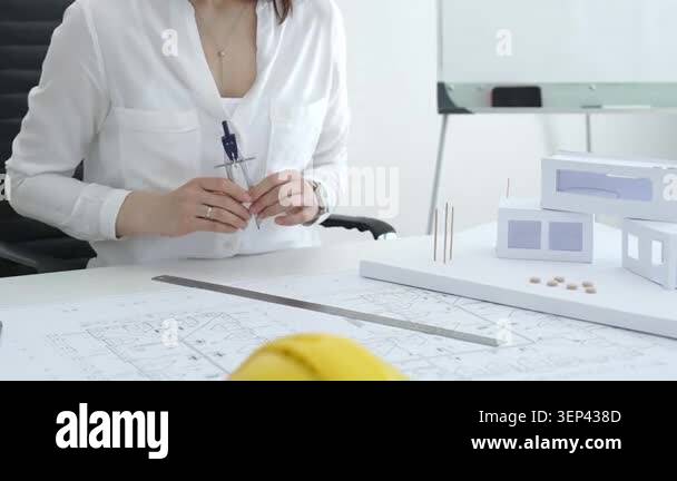 Architect hands measuring and drawing on a blueprint, developing modern ...