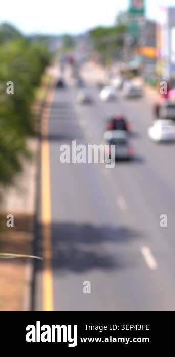 Out of focus bokeh of cars driving on an asphalt highway in Thailand ...