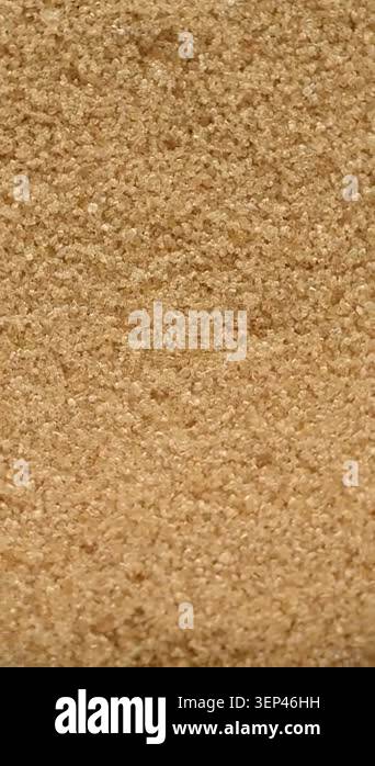 high-angle, macro shot showcasing a detailed texture of unrefined brown ...
