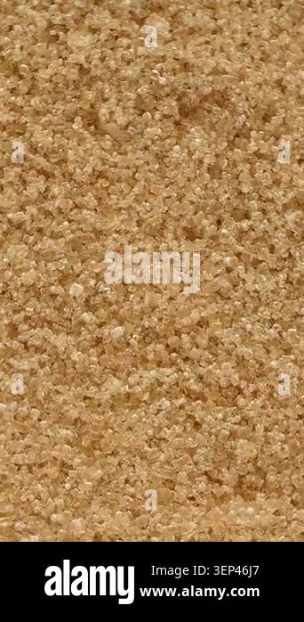 high-angle, macro shot showcasing a detailed texture of unrefined brown ...