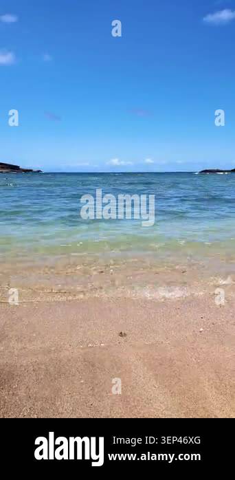 Beautiful vertical shot of calm turquoise sea water rippling on a ...