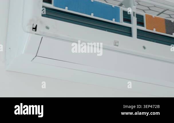 Open wall mounted air conditioner with colored filters and the inside ...