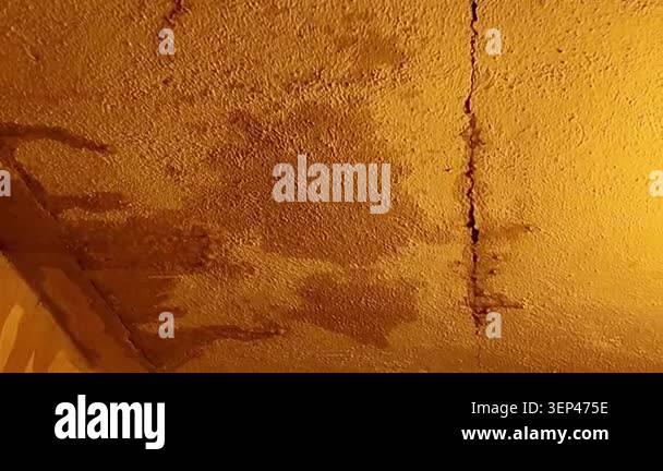 Close-up of textured wall with water stains and cracks, showing signs ...