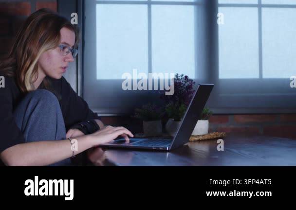 Young girl studies and Works on computer Laptop and surfs the internet ...