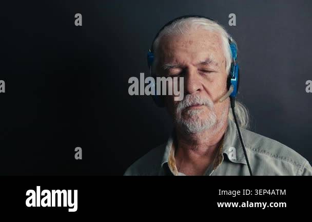 Senior Old Man Listening to Music with Headphones Stock Video Footage ...